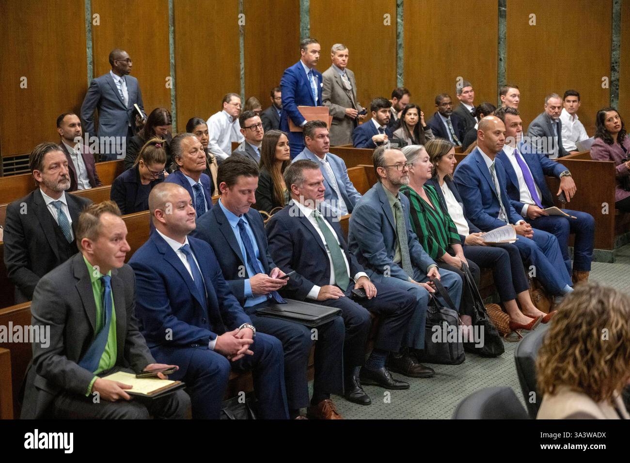 People fill the courtroom during a court proceeding about lawsuits ...
