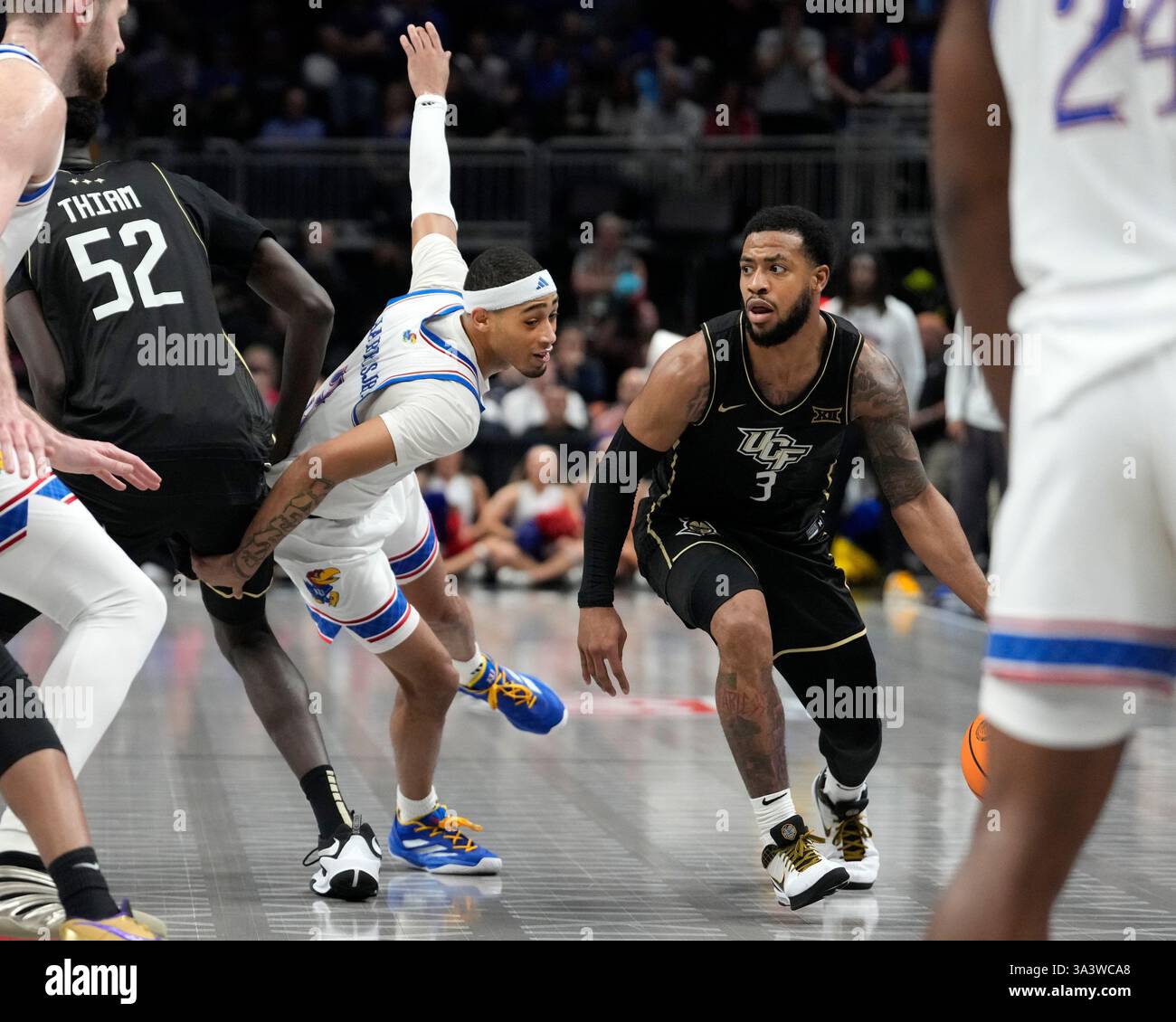 MAR 12 2025: Kansas Jayhawks guard Dajuan Harris Jr. (3) fights through ...
