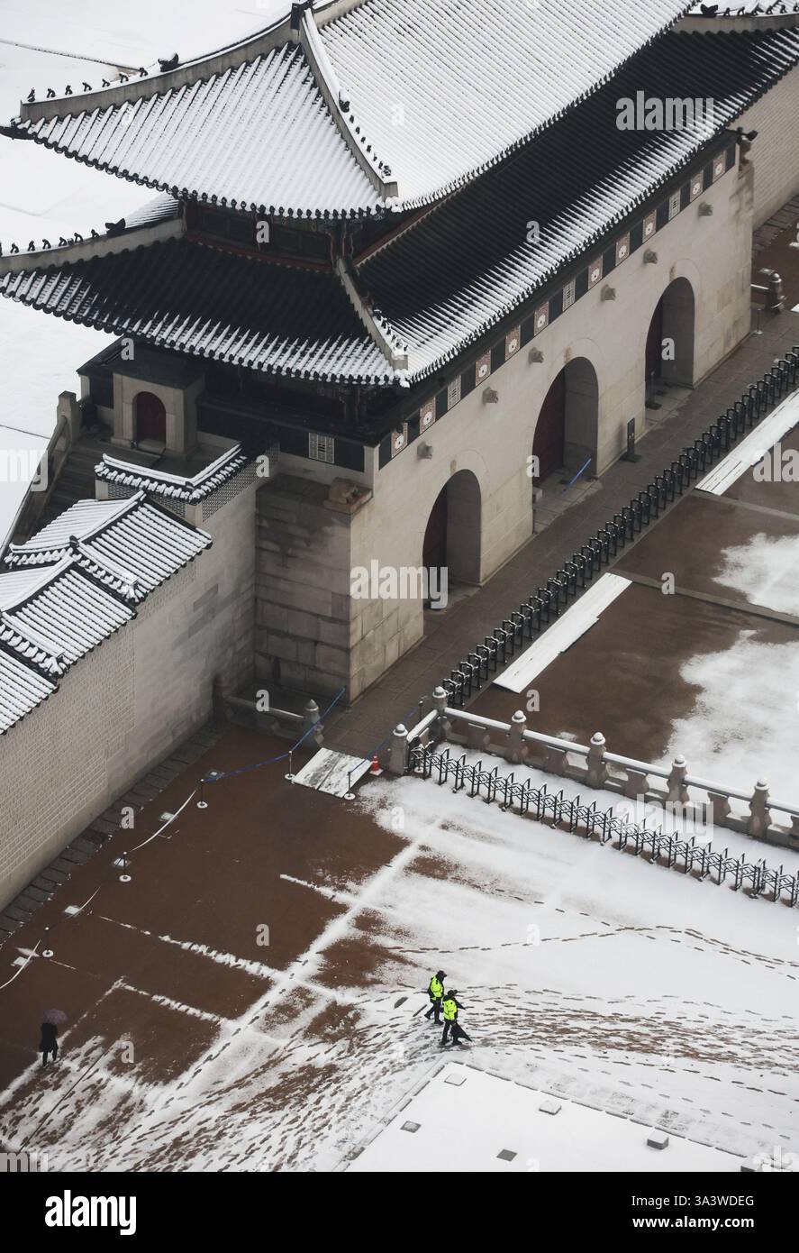 18th Mar, 2025. Snowfall in Seoul Police officers patrol around ...