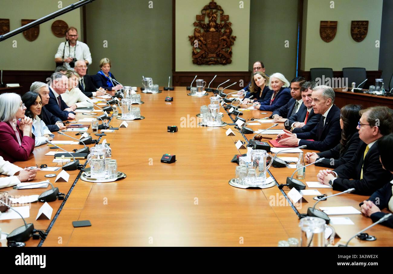 Prime Minister Mark Carney is joined by his cabinet as he speaks before ...
