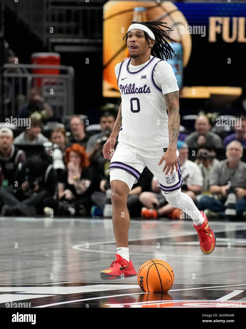 MAR 11 2025: Kansas State Wildcats guard Dug McDaniel (0) displays how ...