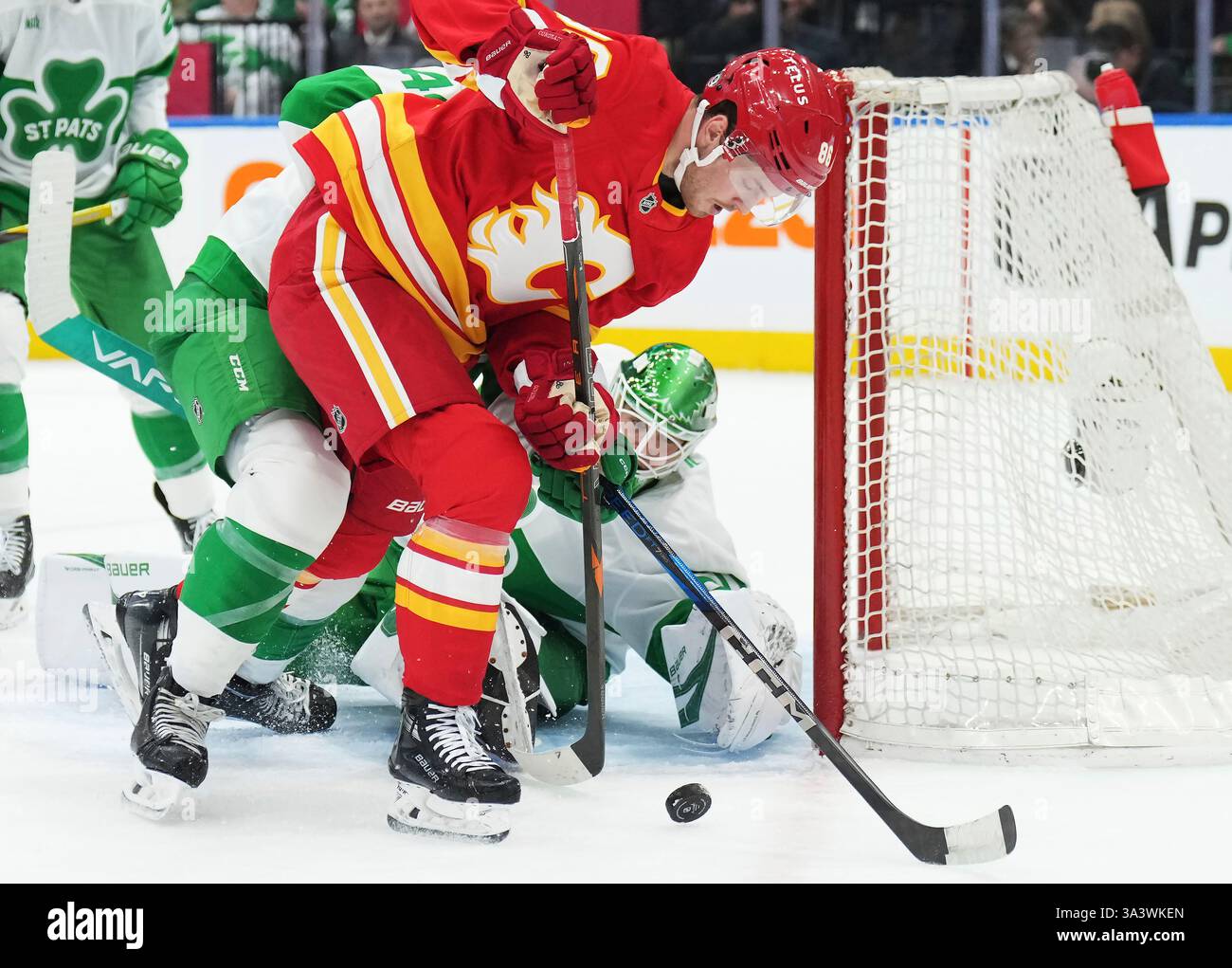Toronto Maple Leafs goaltender Joseph Woll, bottom right, stops Calgary ...