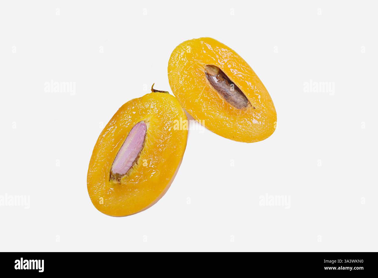 A ripe mayong chit or marian plum fruit (Bouea macrophylla), cut ...