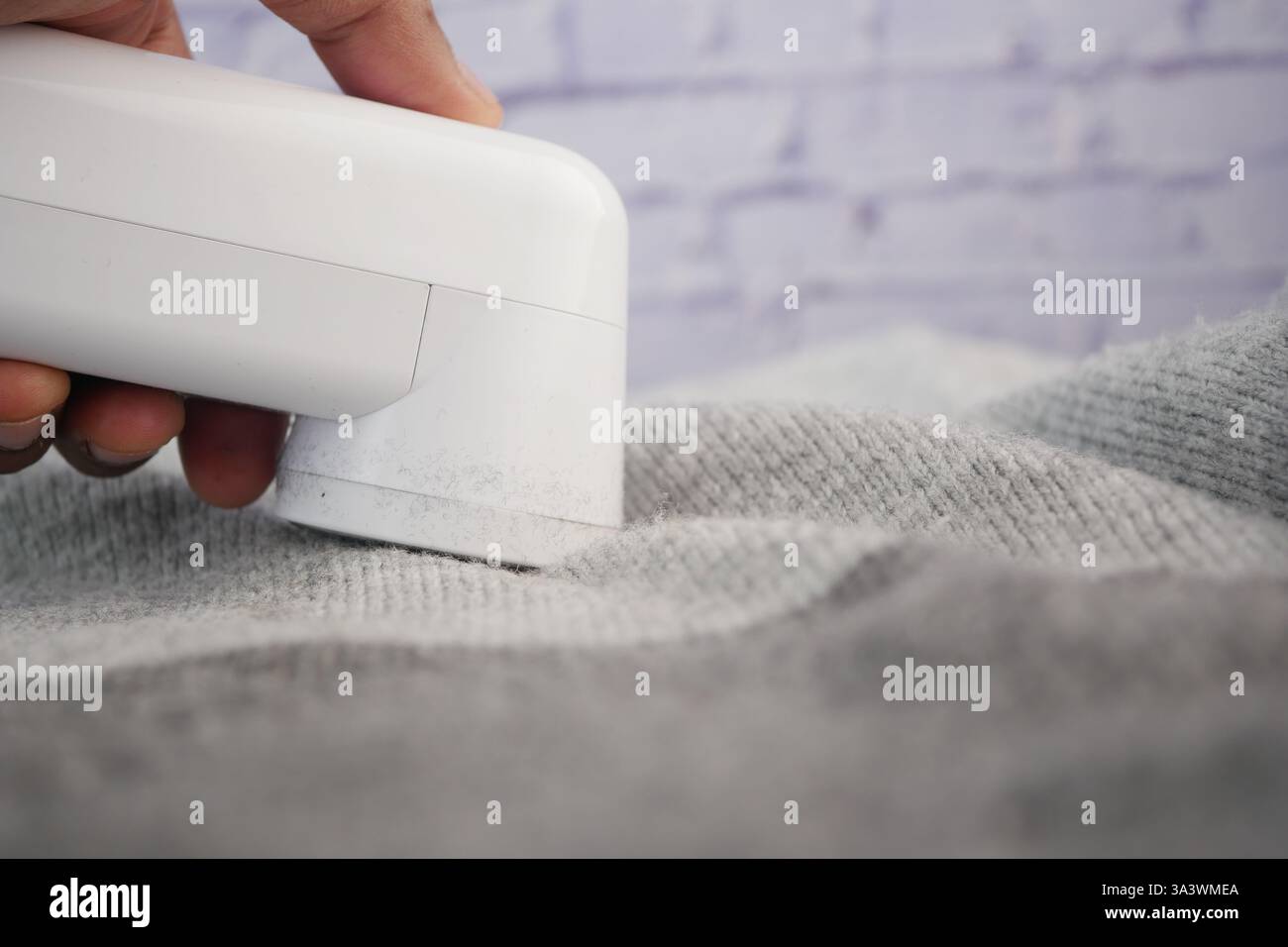 How to effectively remove lint from clothing using a lint remover Stock ...