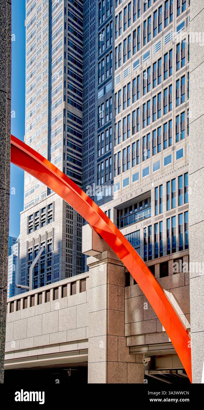 Red steel sculpture and colonnade of the Tokyo Metropolitan Government ...