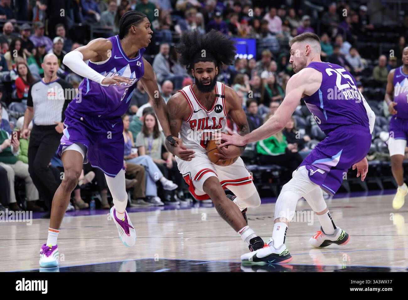 Chicago Bulls guard Coby White (0) drives between Utah Jazz forward ...