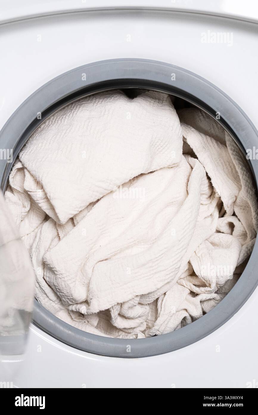 White Clothes Into Washing Machine Stock Photo - Alamy