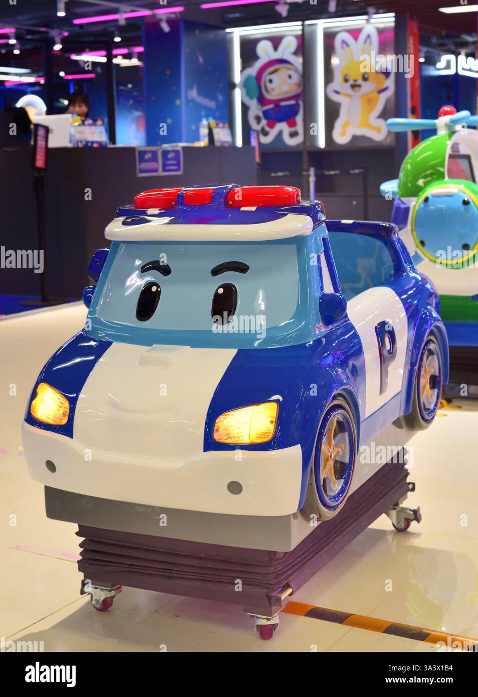 Indoor kiddie ride game machine police car in game parlor Stock Photo ...