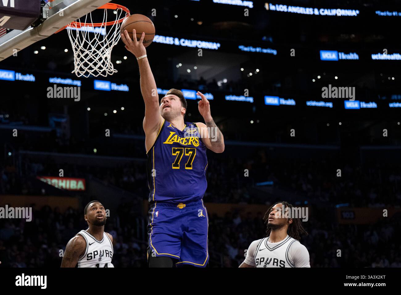 Los Angeles Lakers guard Luka Doncic, center, goes up for a basket past ...