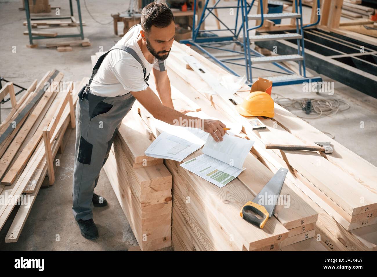Bunch of paper documents and plans. Industrial worker in wooden ...