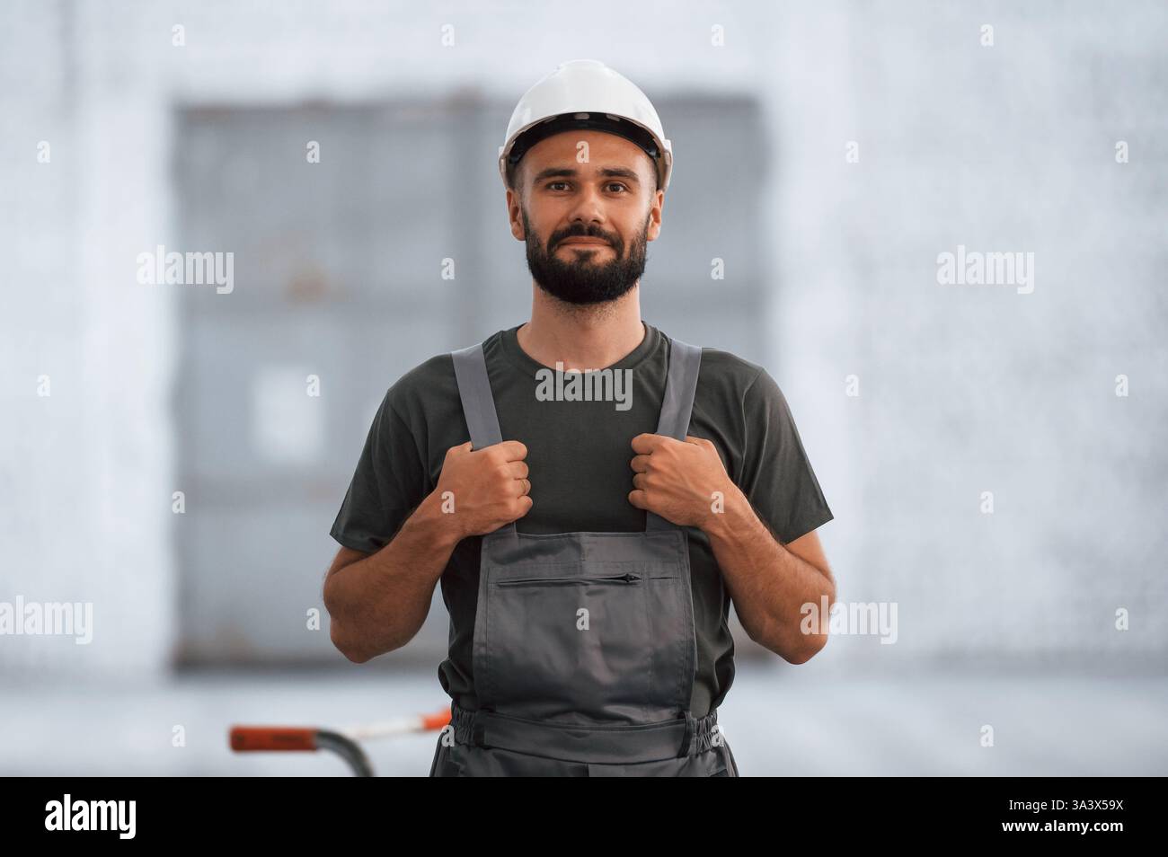 Beautiful portrait. Male worker is in the empty warehouse Stock Photo ...
