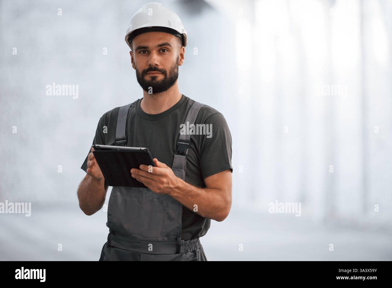 Beautiful portrait. Male worker is in the empty warehouse Stock Photo ...