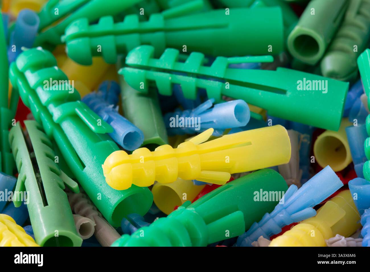Pile of assorted sizes wall plugs background backdrop. Construction do ...
