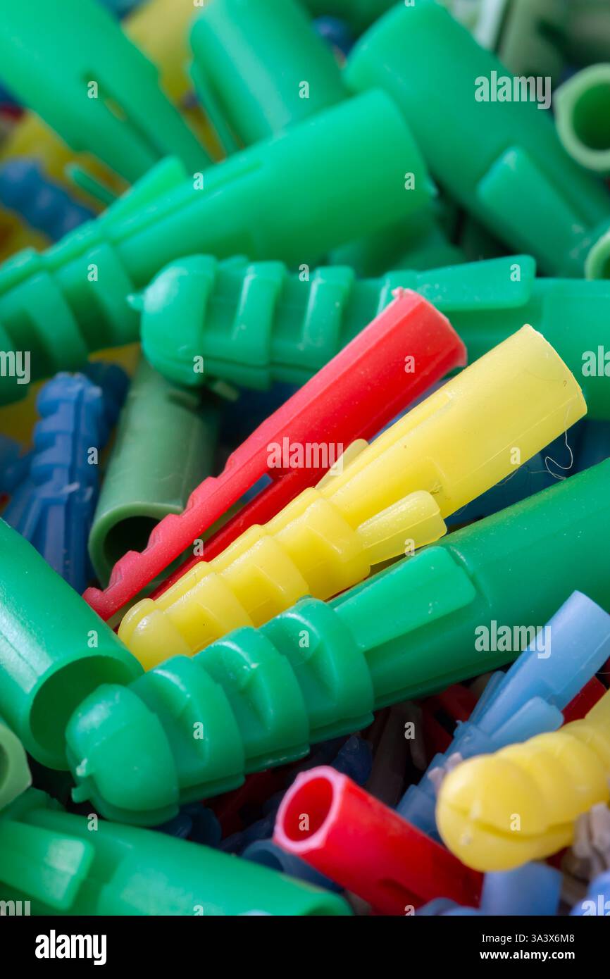 Pile of assorted sizes wall plugs background backdrop. Construction do ...