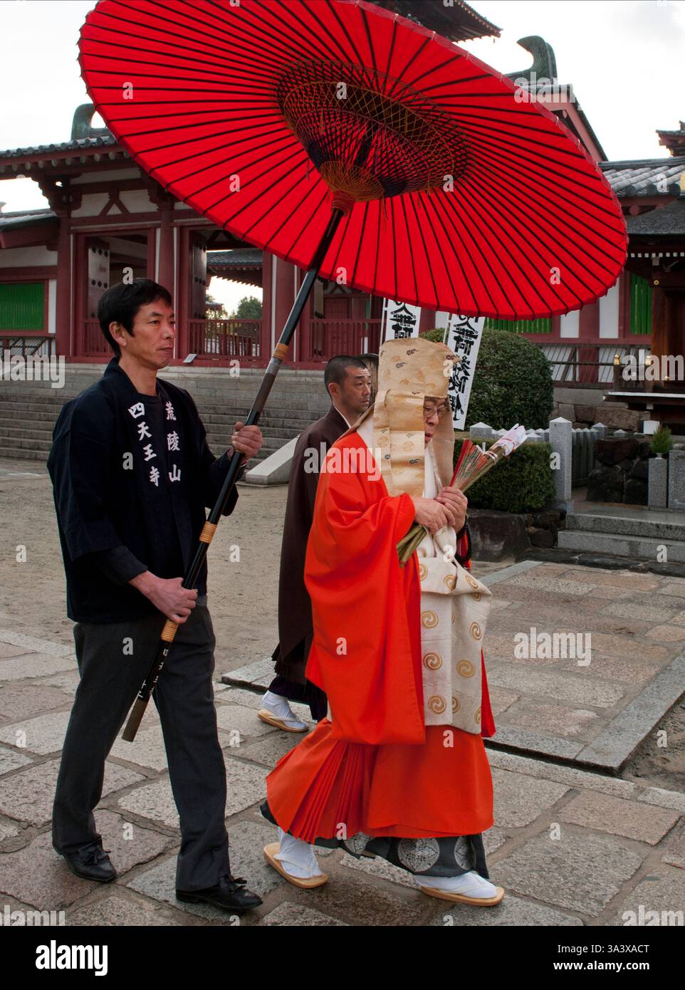 A procession of Buddhist priests including the head priest under the ...