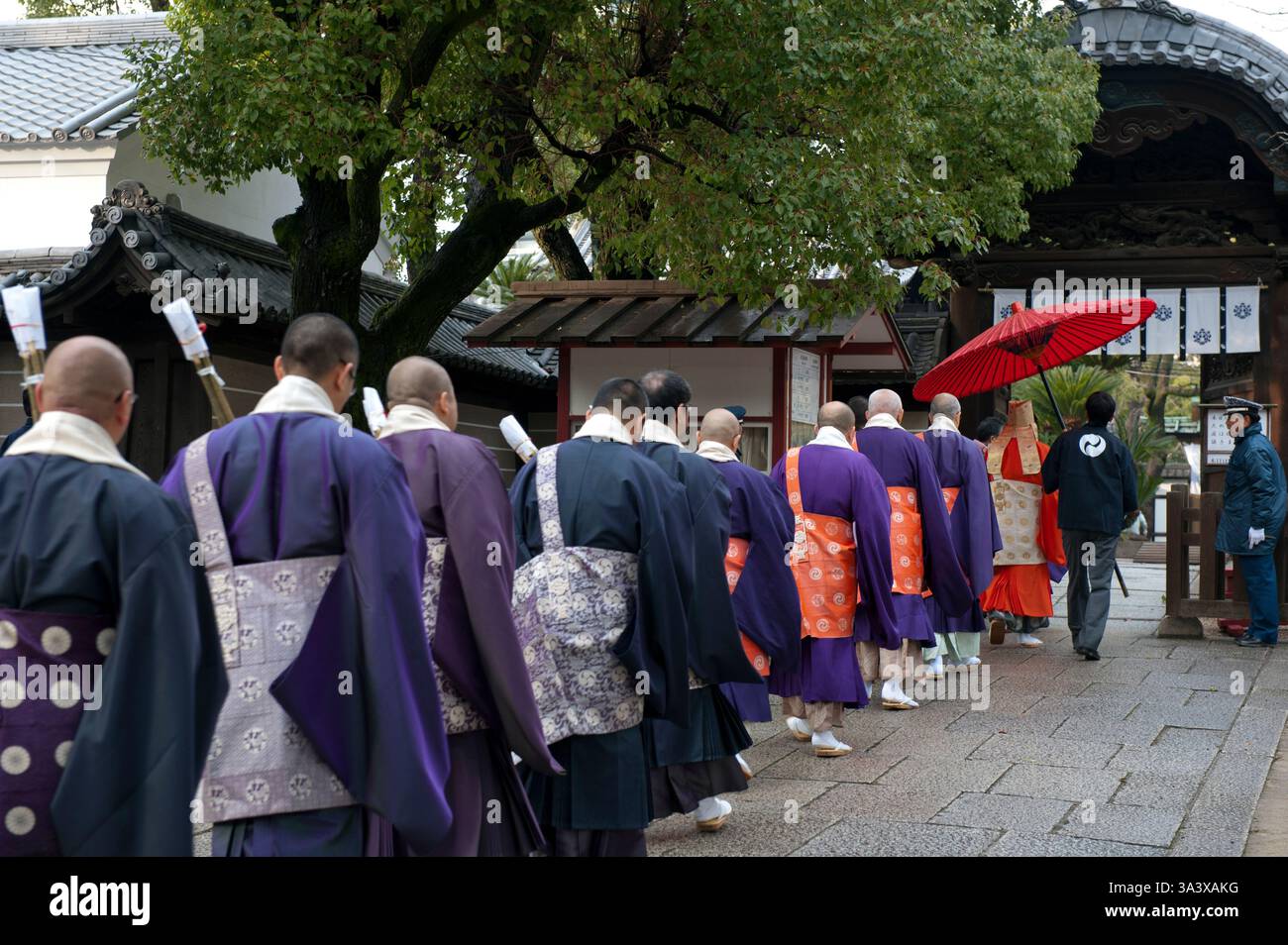 A procession of Buddhist priests including the head priest under the ...
