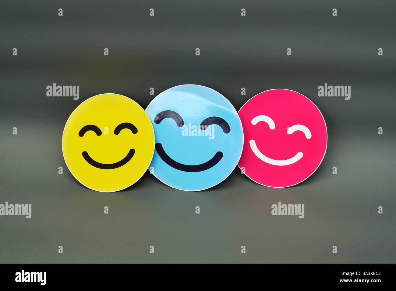 Colorful Smiley Faces on Green Background Representing Happiness, Joy ...