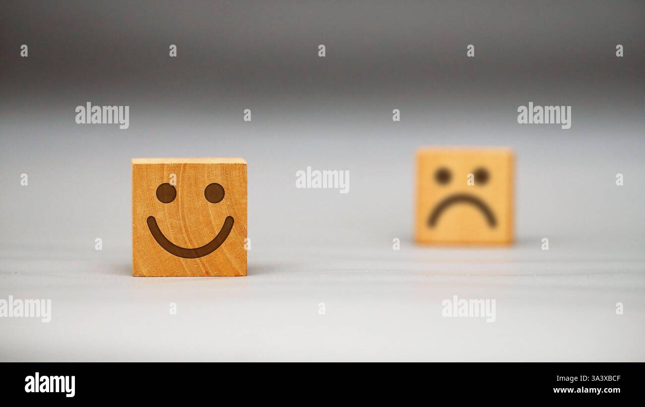 Emotional Duality Concept with Wooden Block Showing Happy and Sad Faces ...
