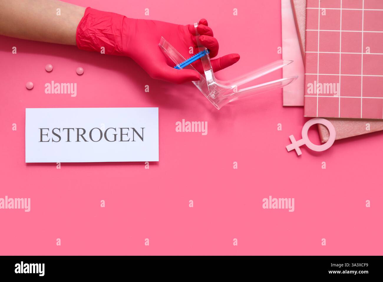 Doctor holding gynecological speculum with word ESTROGEN, hormonal ...