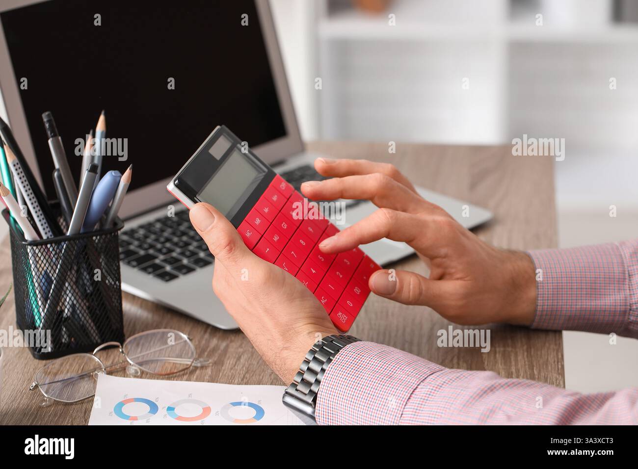 Male hands doing calculations in office. Closeup Stock Photo - Alamy