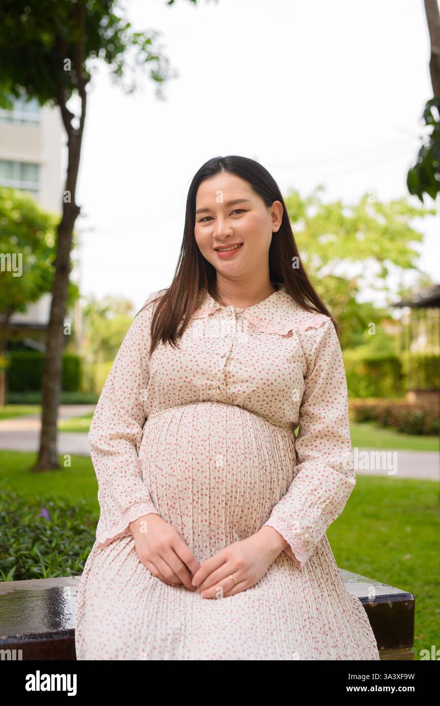 Pregnant Asian woman portrait outdoors Stock Photo - Alamy