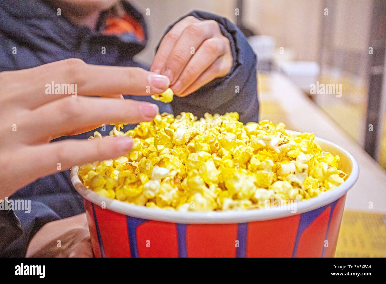 eating popcorn in the cinema before watching a movie. family weekend ...