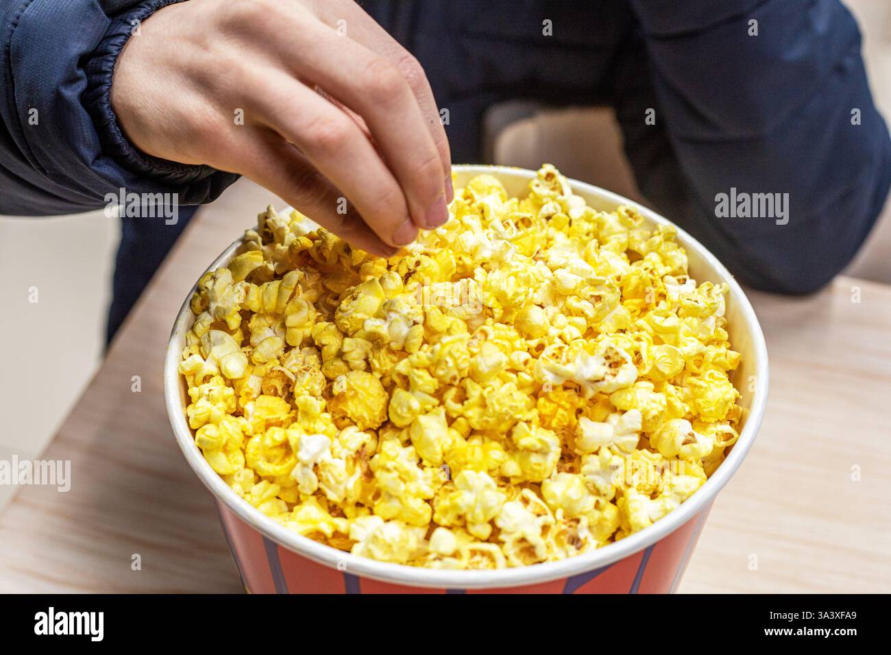 eating popcorn in the cinema before watching a movie. family weekend ...