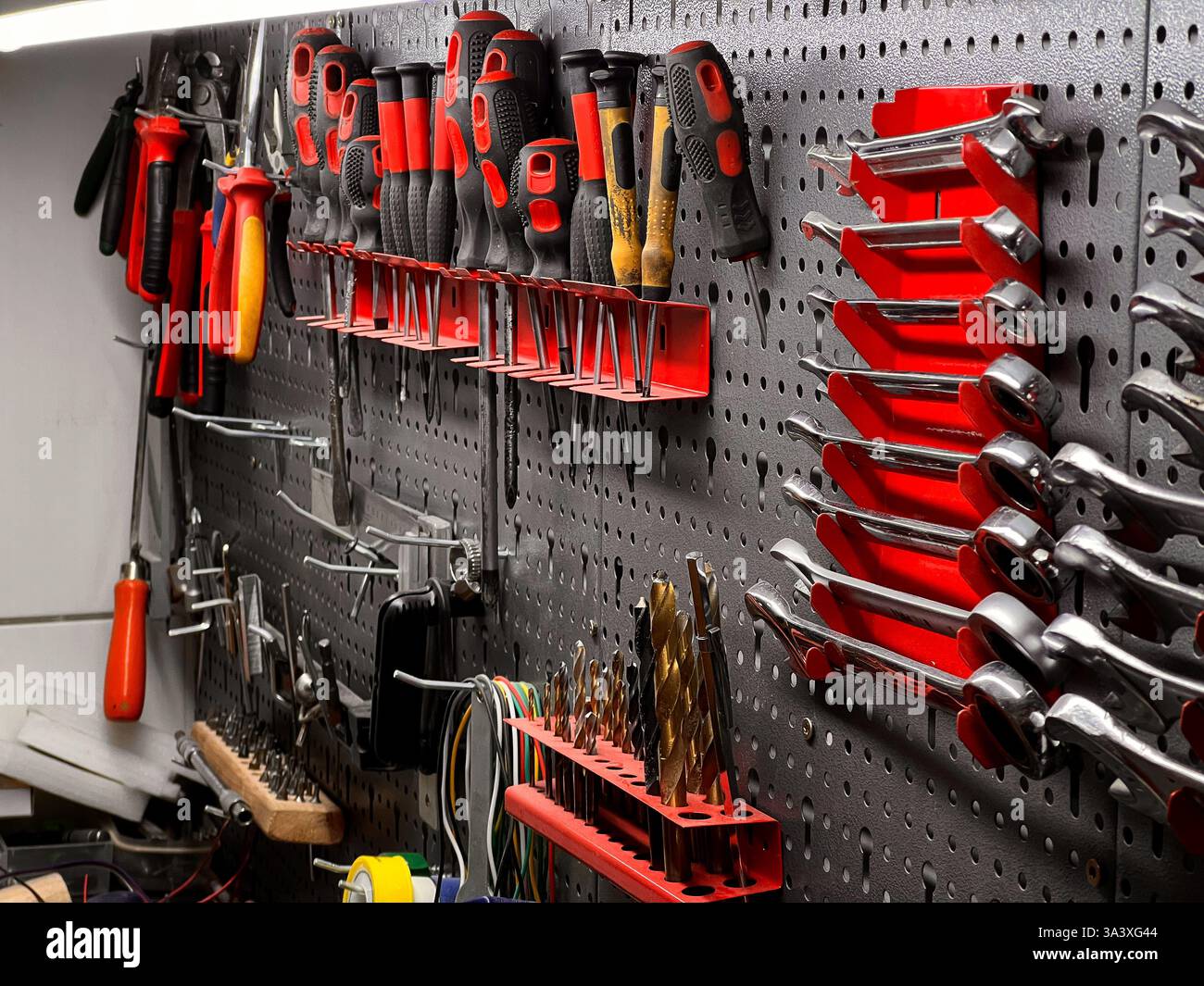 Set of organized different tools hanging on a wall in a garage Stock ...