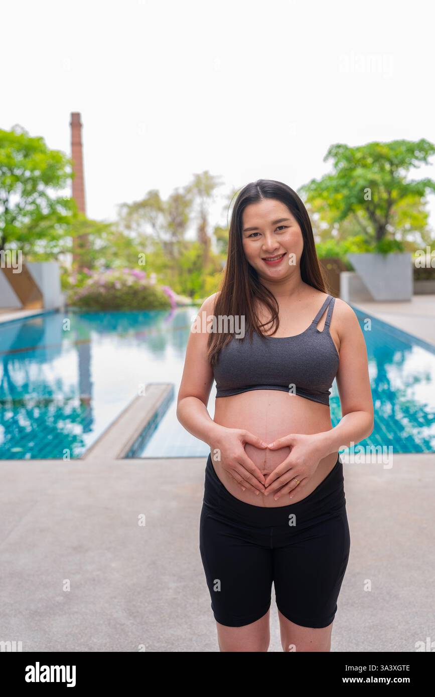 Pregnant Asian fitness woman at swimming pool Stock Photo - Alamy