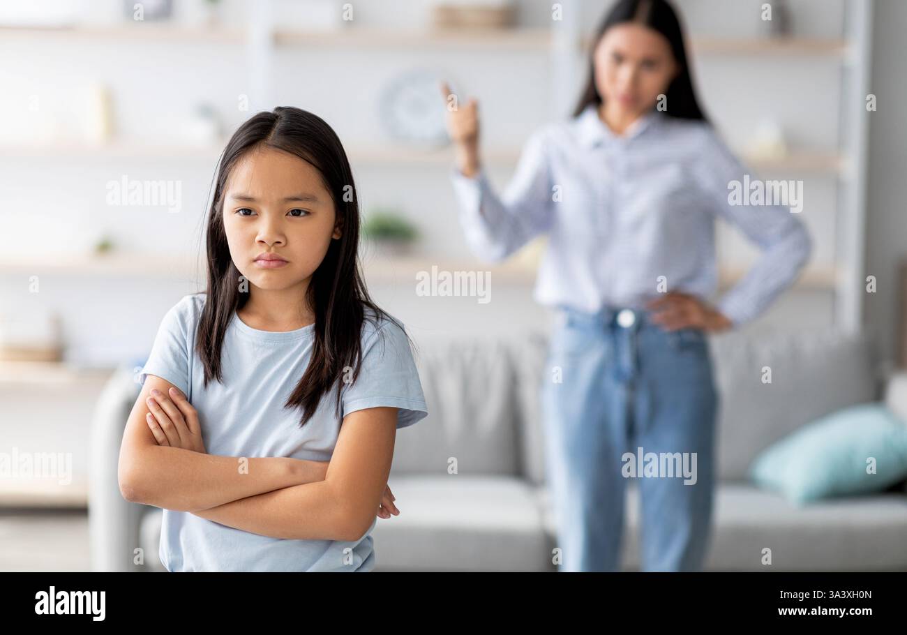 Family conflict. Mother and daughter quarreling at home, girl ignoring her mom, standing back to ...