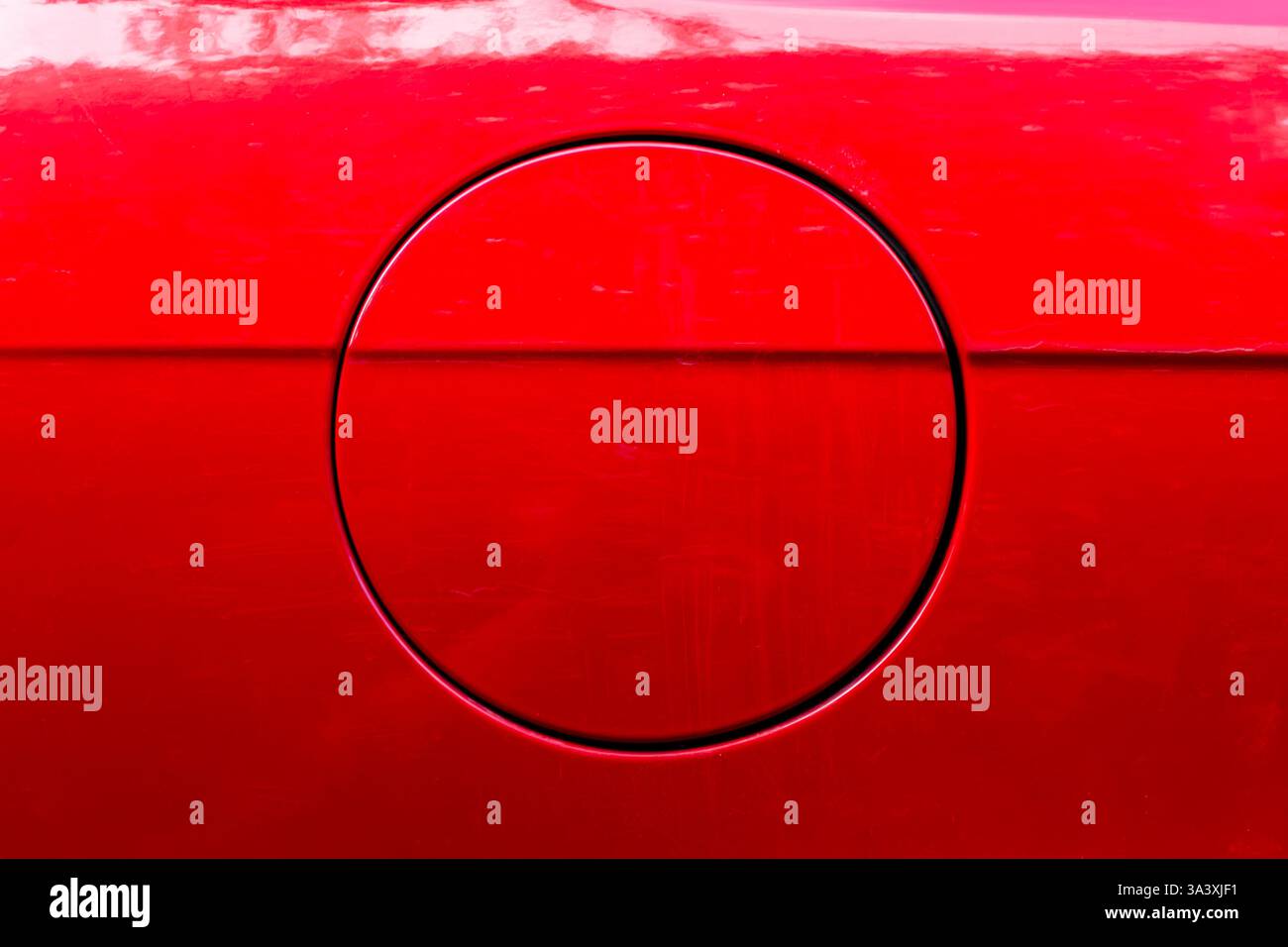 Close-up of a round fuel tank cap on the back of a red car Stock Photo ...