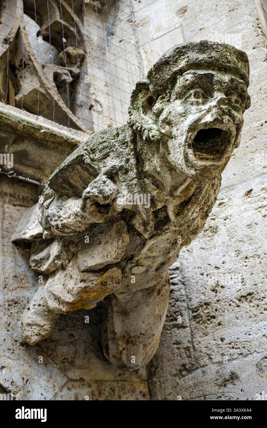 Sculpture of a male figure as a gargoyle, neo-Gothic architectural ...