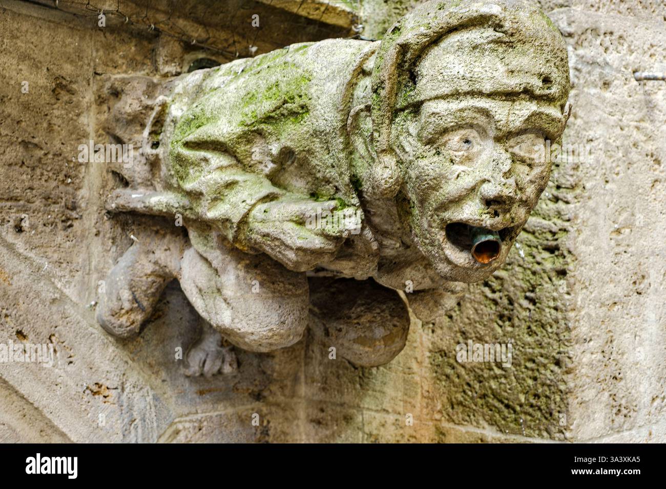 Sculpture of a male figure as a gargoyle, neo-Gothic architectural ...