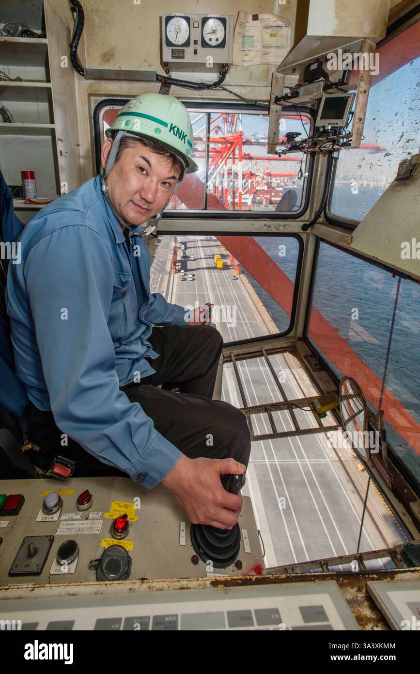Cargo is loaded onto cargo ships at the kana container yard in Tokyo ...