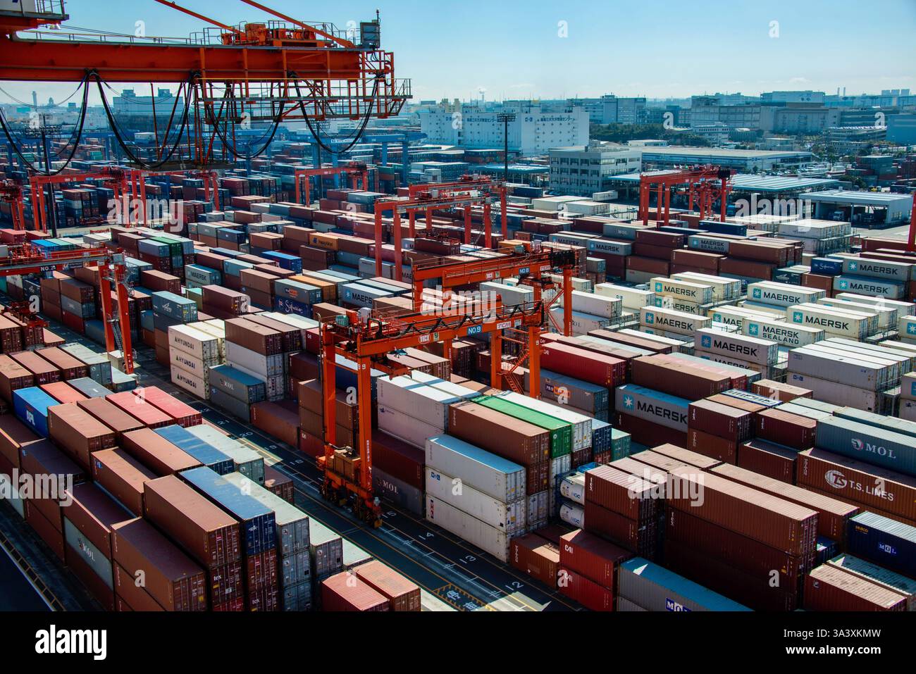 Cargo is loaded onto cargo ships at the kana container yard in Tokyo ...
