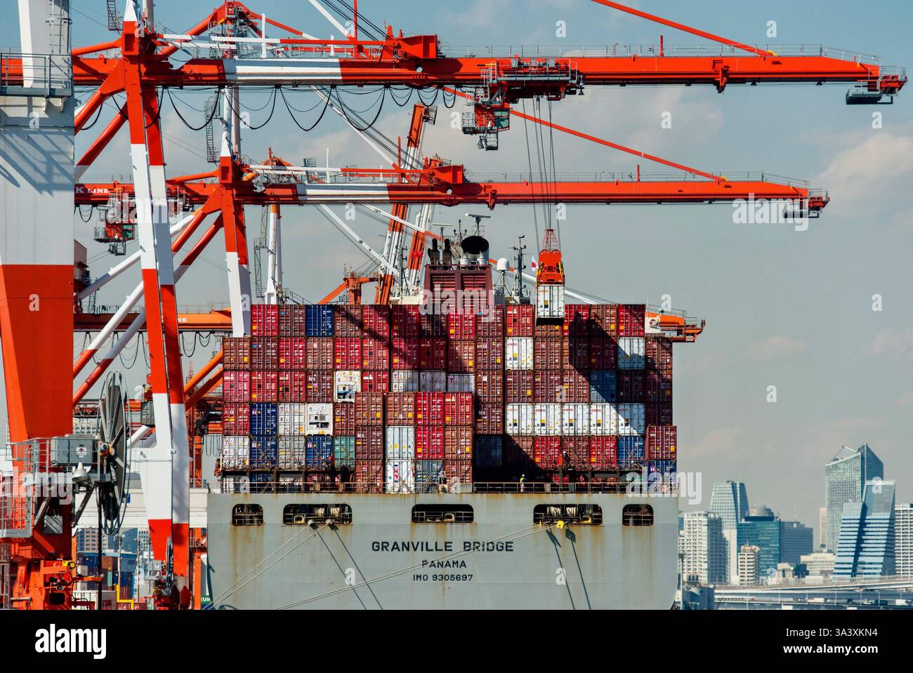 Cargo is loaded onto cargo ships at the kana container yard in Tokyo ...