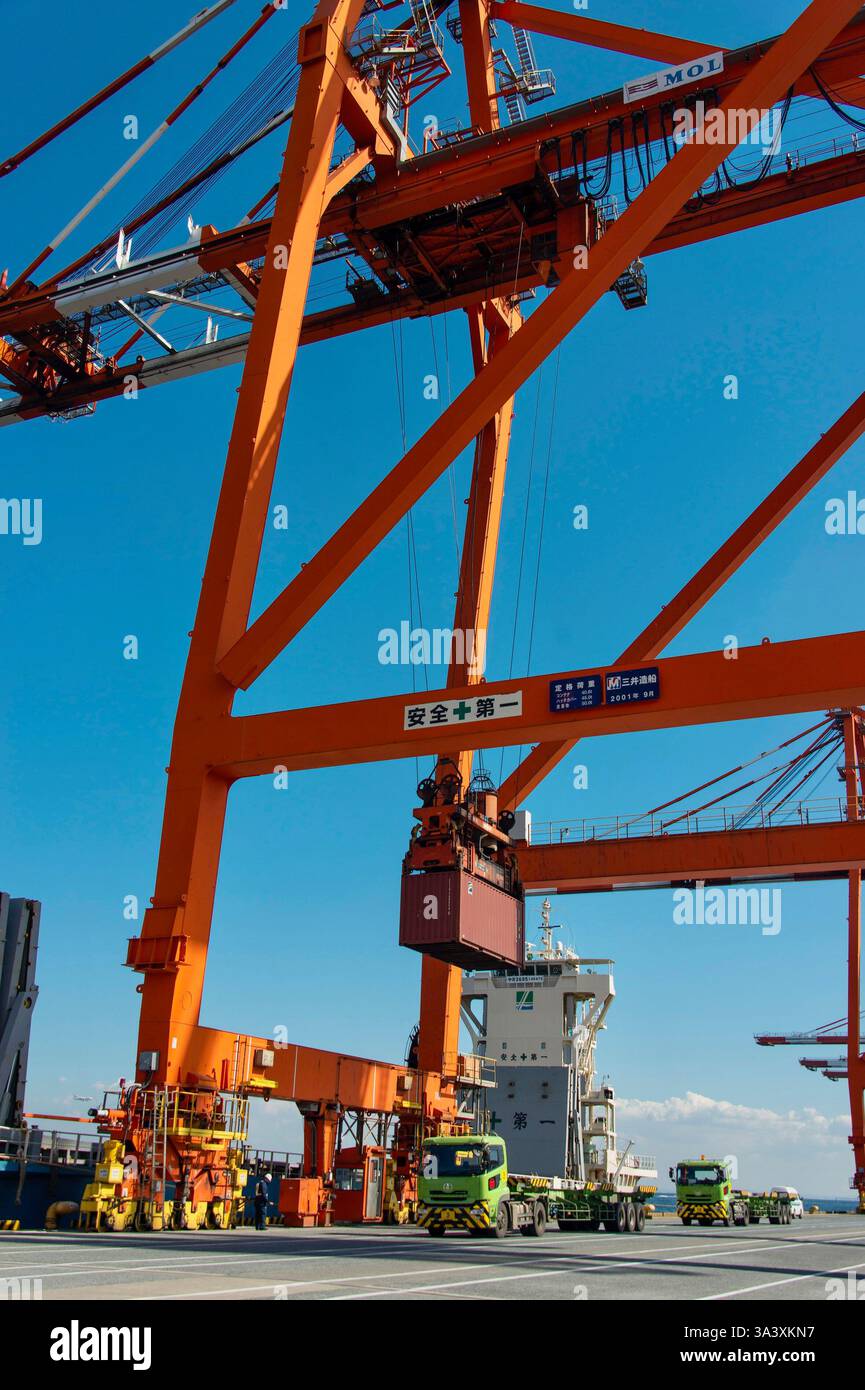 Cargo is loaded onto cargo ships at the kana container yard in Tokyo ...