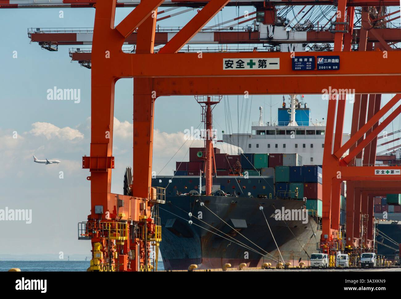 Cargo is loaded onto cargo ships at the kana container yard in Tokyo ...