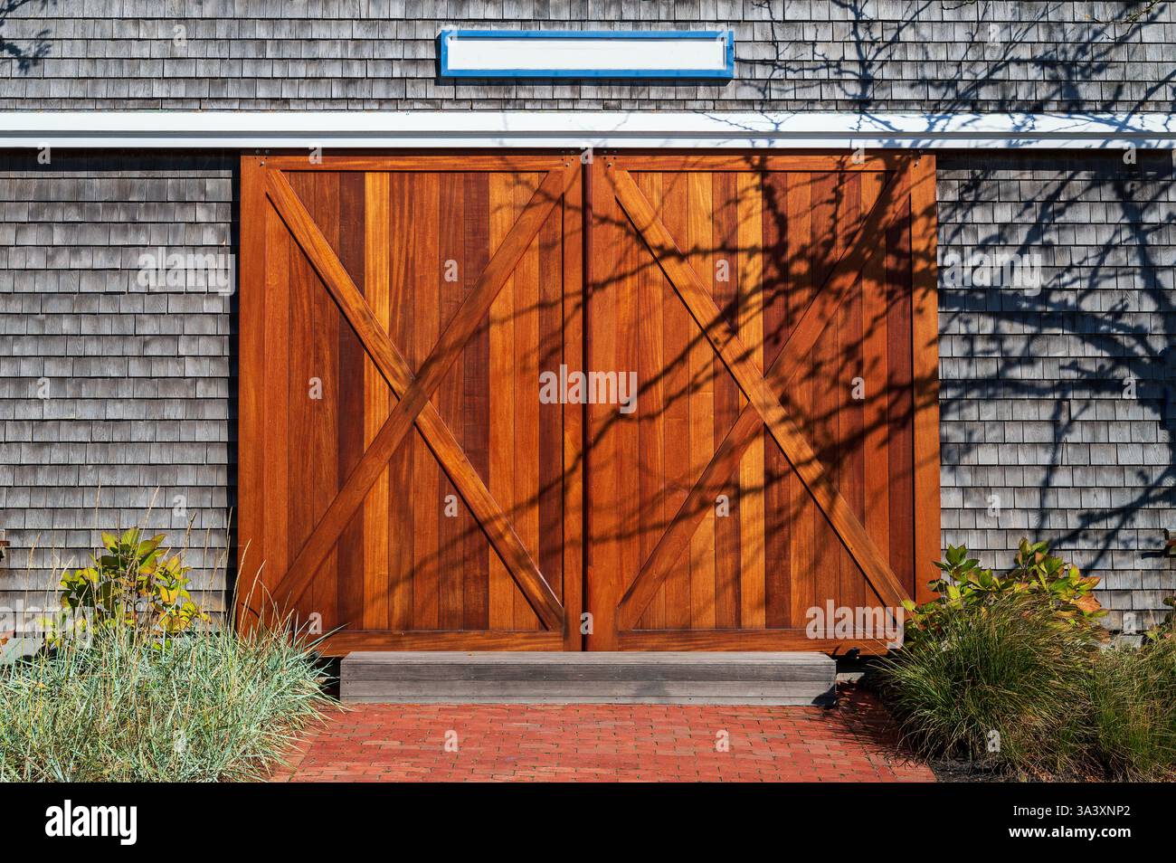Modern exterior barn style sliding wooden door on shingles covered ...