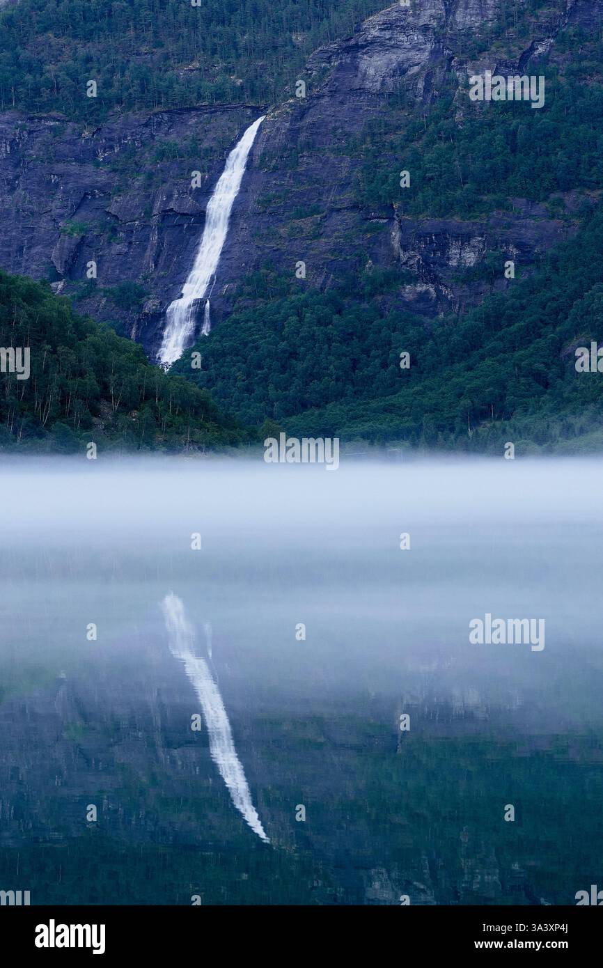 The Aasafossen Waterfall reflected in the Eidsvatnet Lake, Skjolden ...