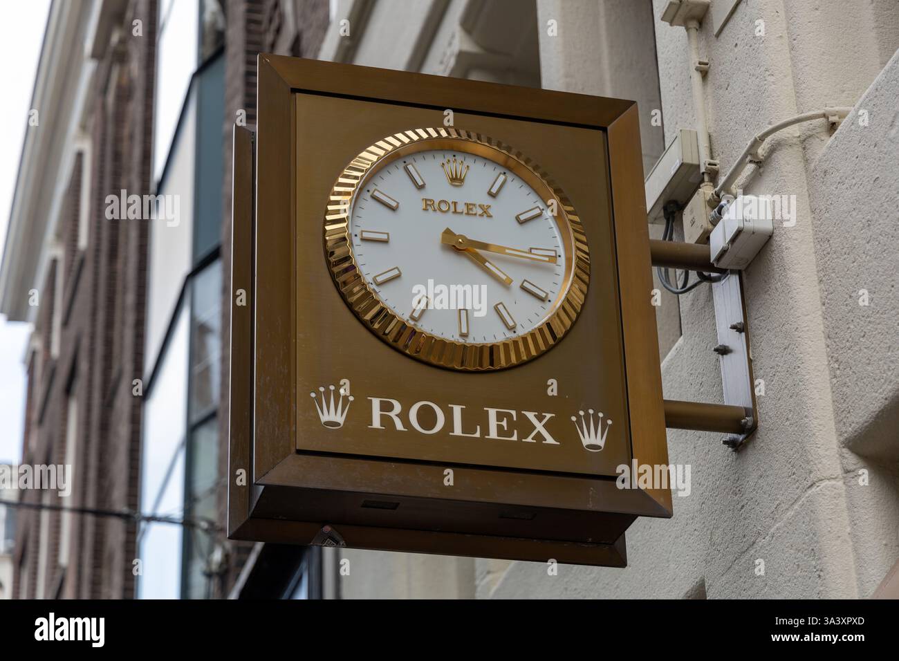 Rolex logo sign and gold brown classic clock hang on the wall at a shop ...