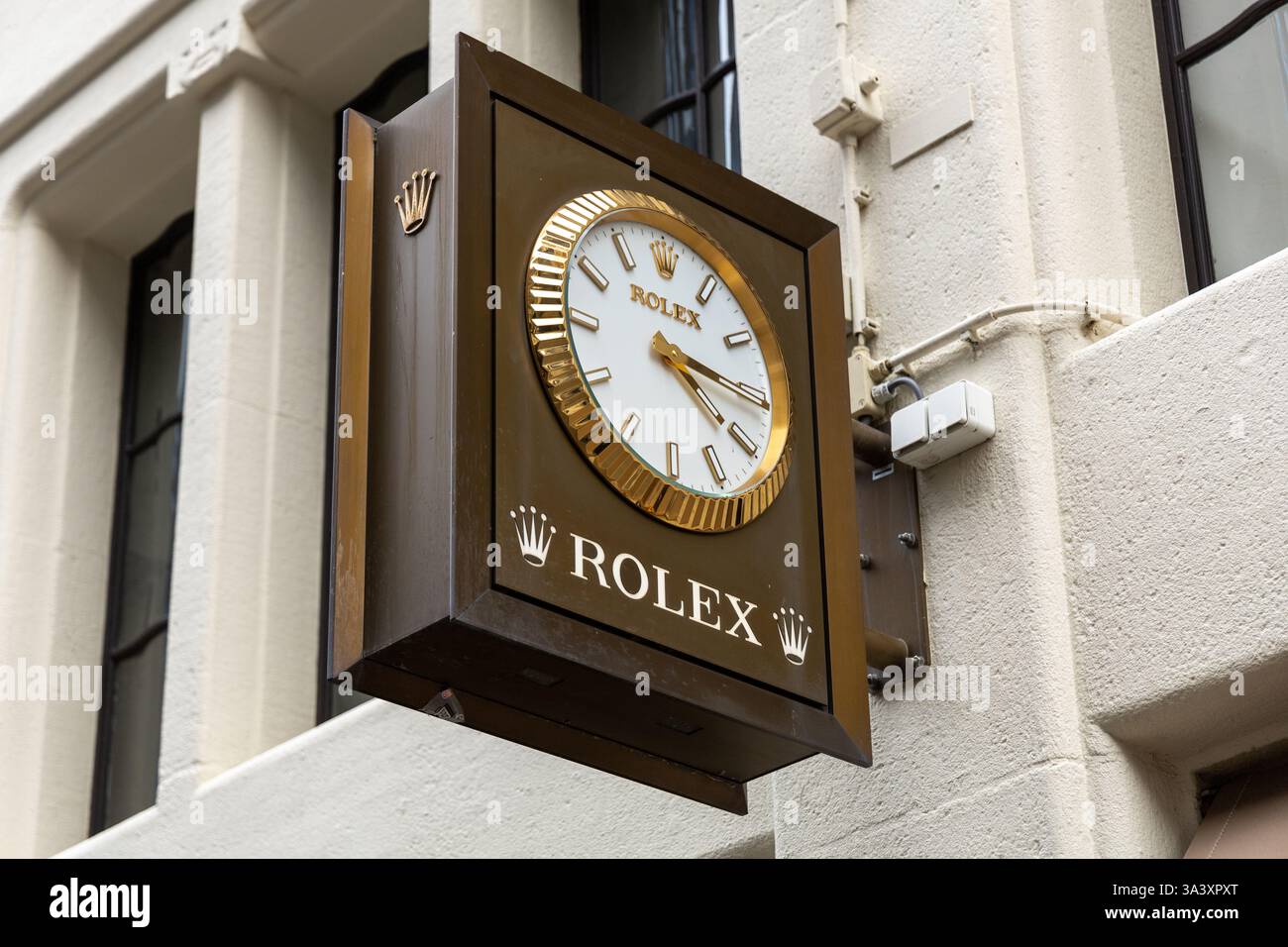 Rolex logo sign and gold brown classic clock hang on the wall at a shop ...