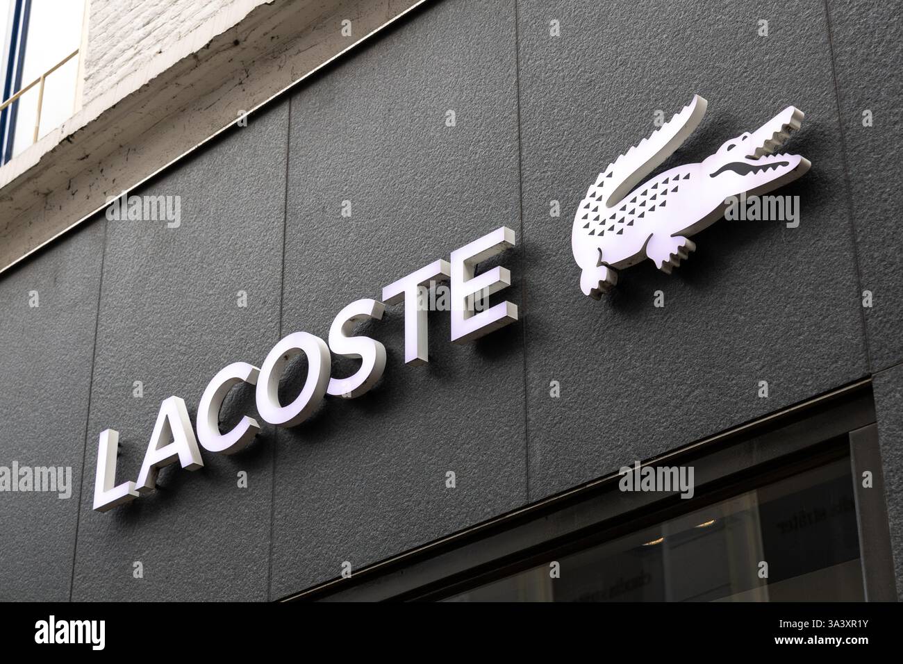 Lacoste logo sign. White letters and crocodile. René Lacoste, a ...
