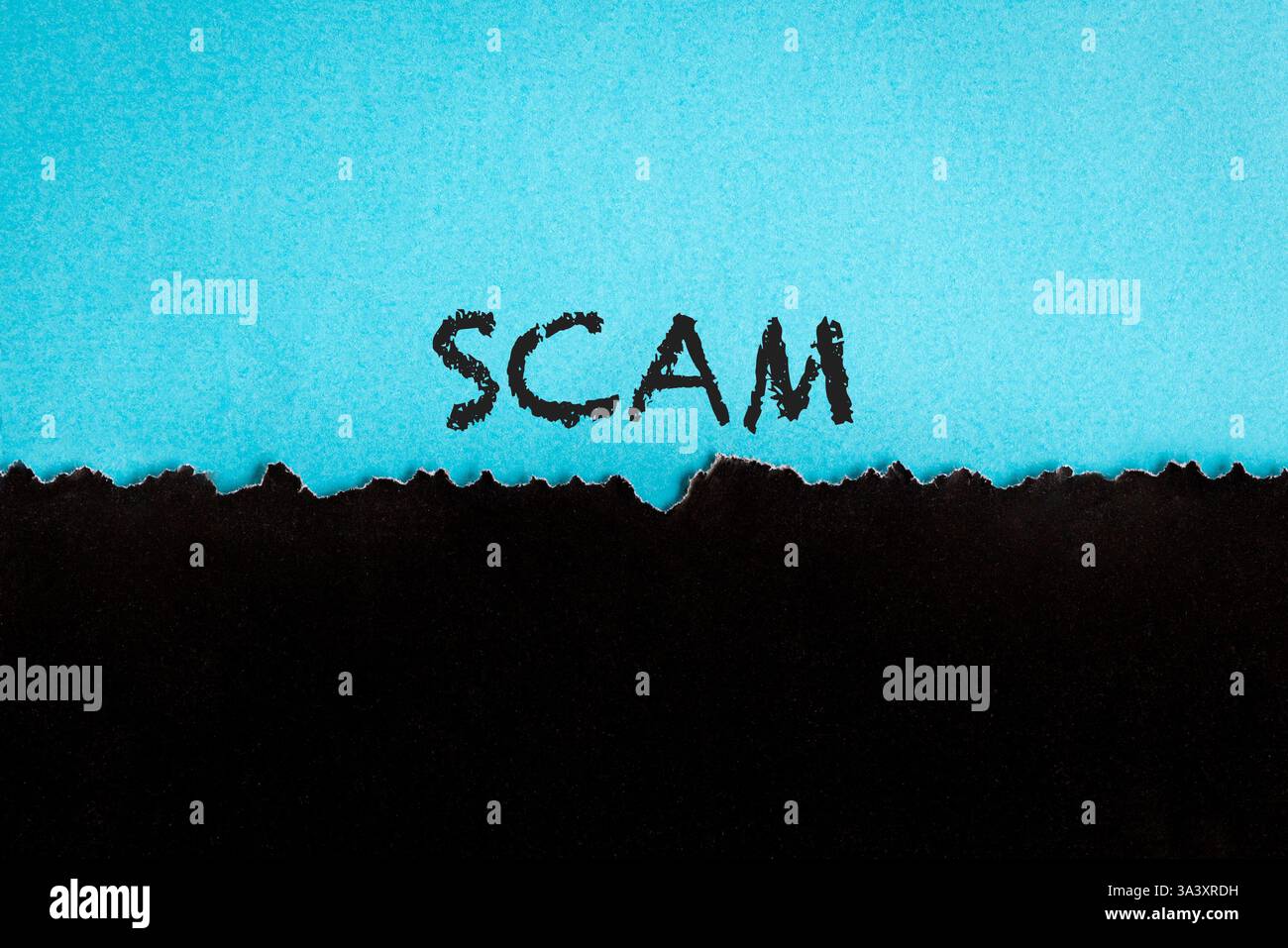 SCAM word on blue paper with torn black paper at the bottom. Message of ...