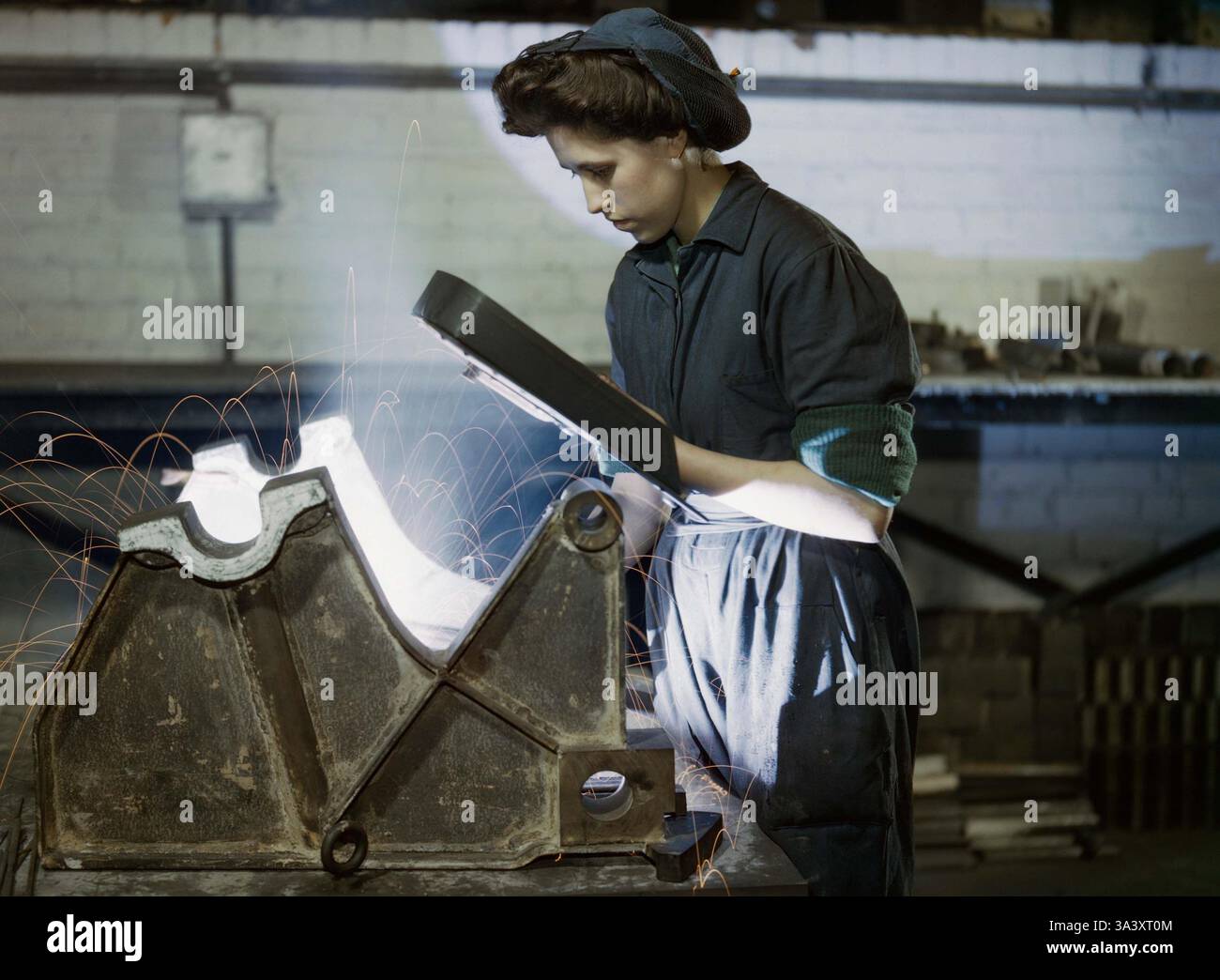 WWII women at work - A welder working on the saddle of a Ordnance QF 25 ...