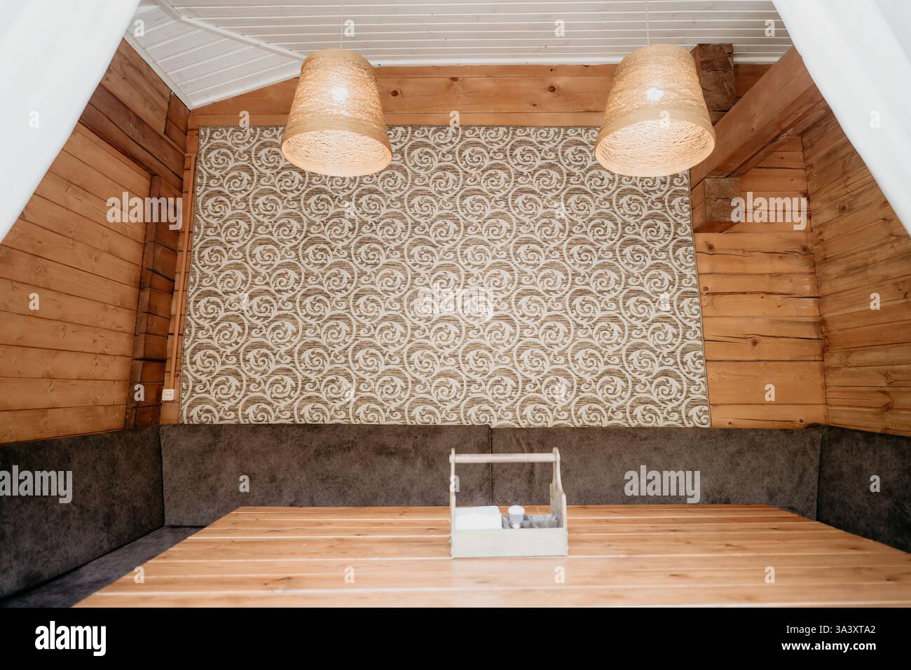 Rustic Wooden Booth with Patterned Wallpaper and Wicker Lights Stock ...