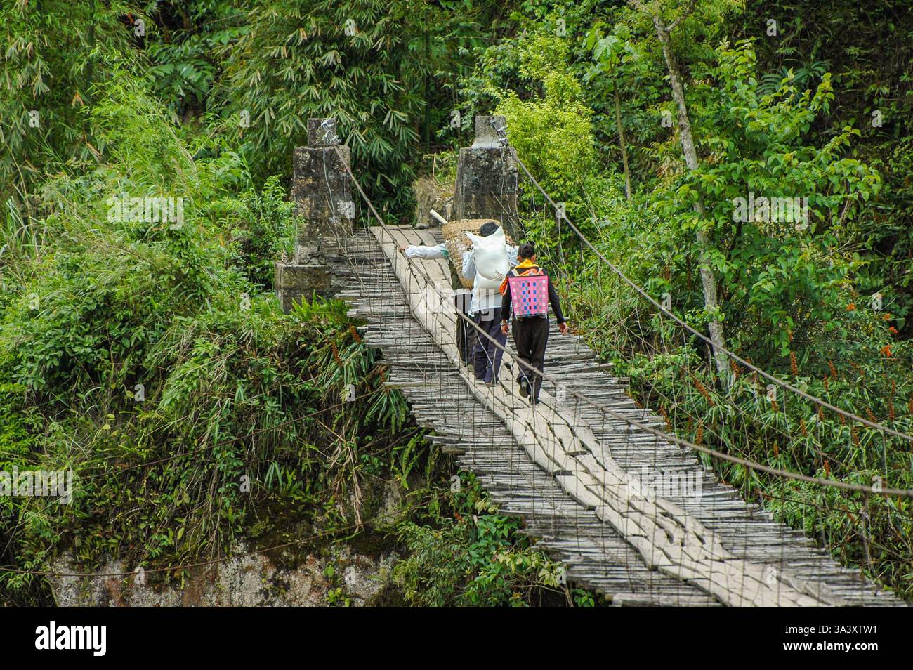 Crossing a precarious suspension bridge over the Nu River Stock Photo ...