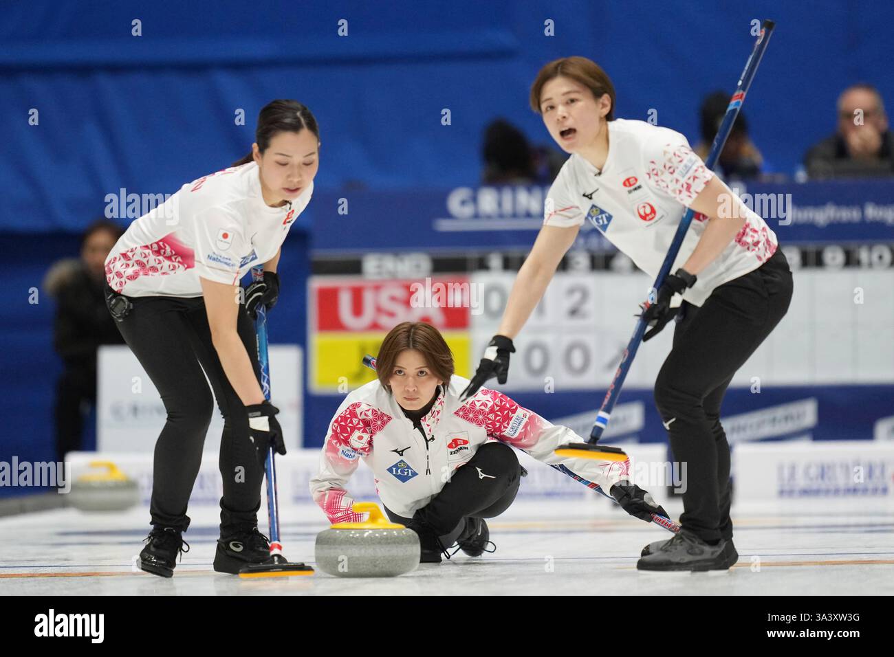 Japan's skip Sayaka Yoshimura, center, releases the stone as Anna ...