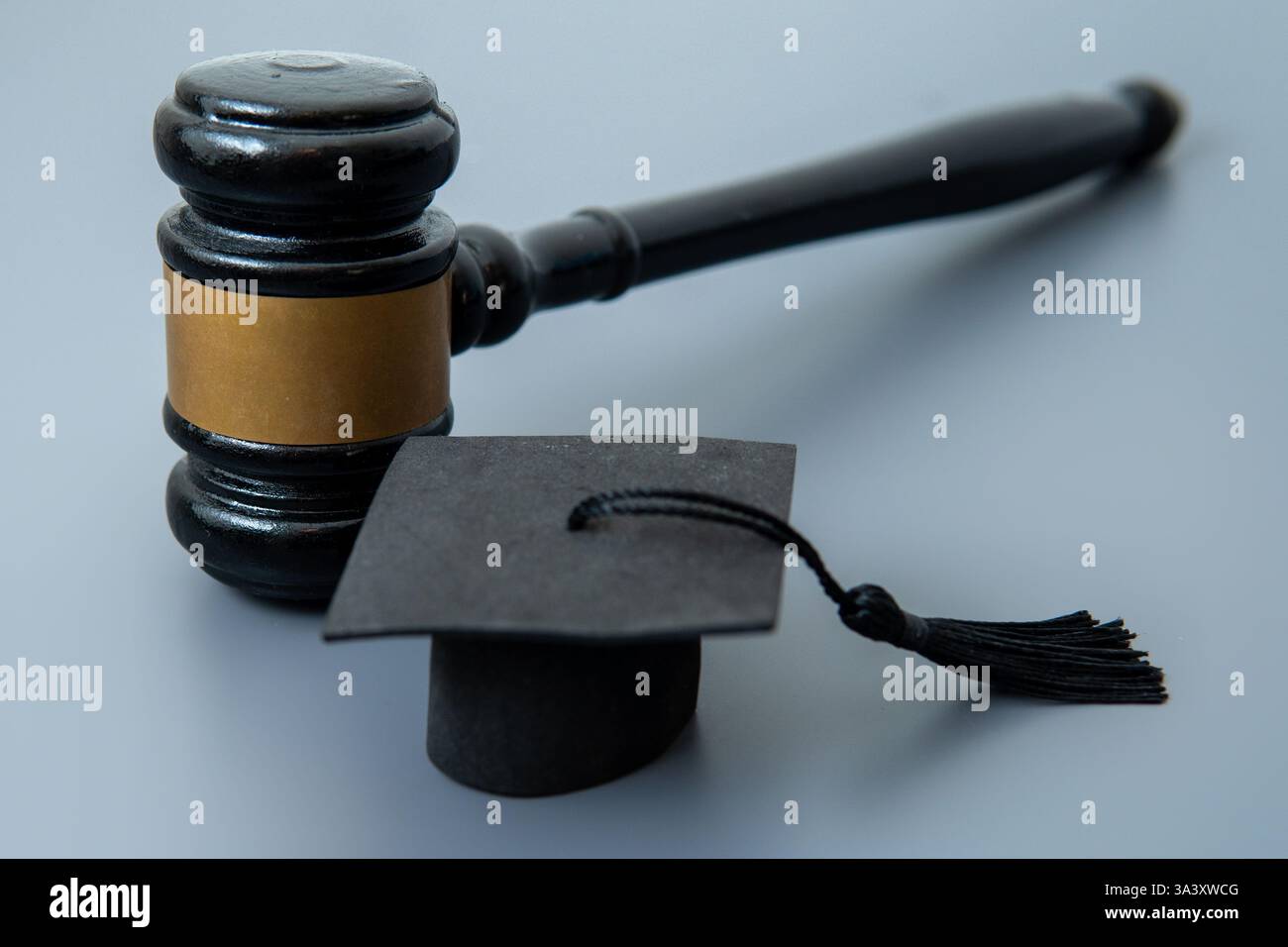 A black gavel and a black graduation cap. Education law concept Stock ...
