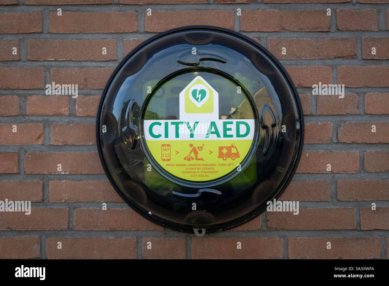 City AED mounted on a stone brick wall. An AED, or automated external ...